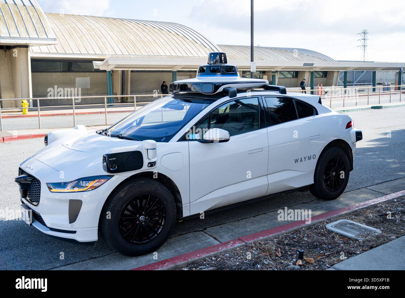 Waymo autonomous electric vehicle with roof-mounted sensors parked at ...