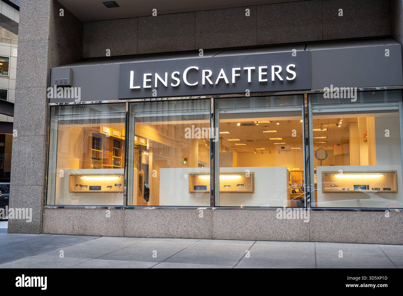 Exterior of LensCrafters eyewear store with illuminated sign and window ...