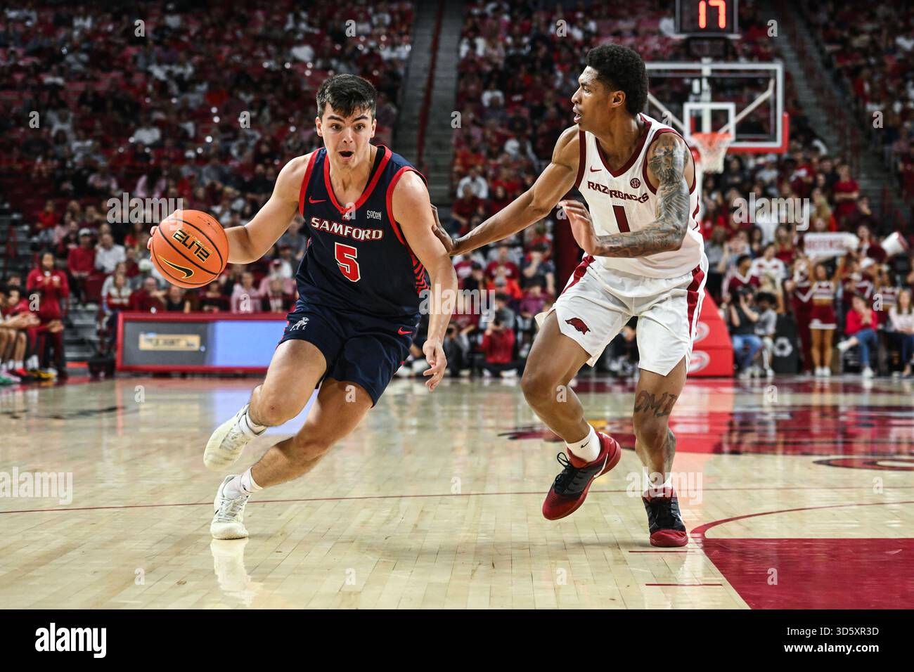 Samford guard Cade Norris (5) tries to get the ball past Arkansas guard ...