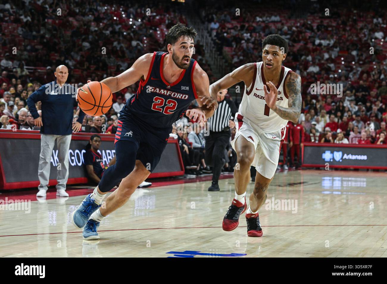 Samford forward Jaxon Pollard (22) tries to drive past Arkansas guard ...