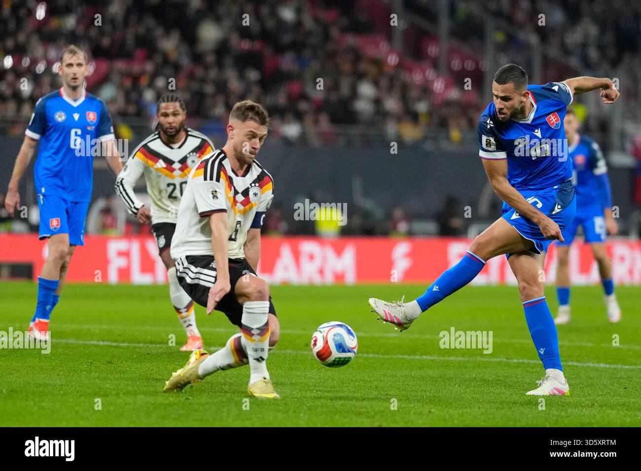 Slovakia's David Hancko shoots by Germany's Joshua Kimmich during a ...