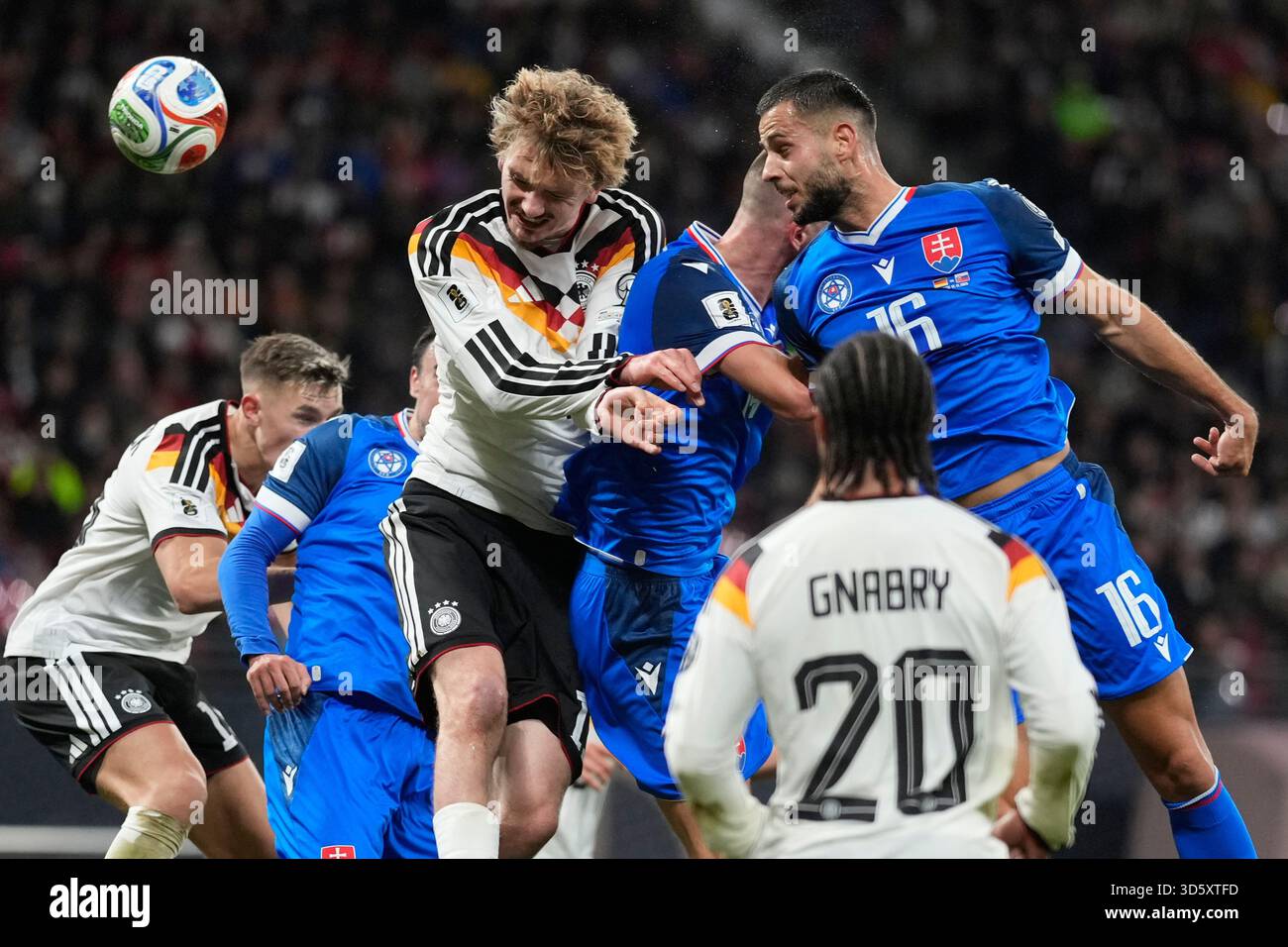 Germany's Nick Woltemade, left, and Slovakia's David Hancko jump for ...