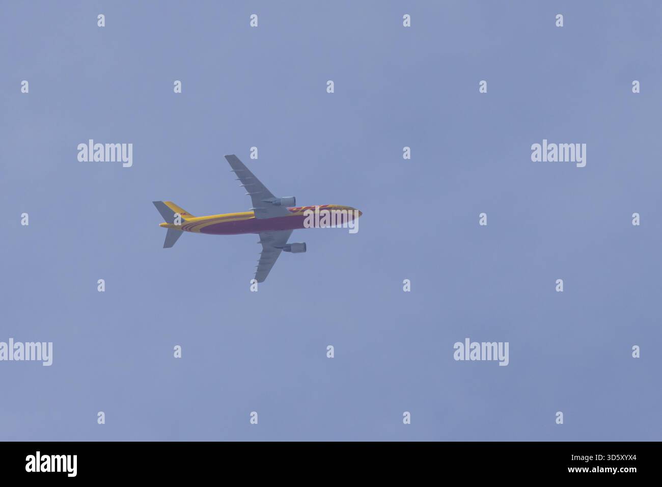 Boeing 767 jet cargo aircraft of DHL airlines flying in a blue sky ...
