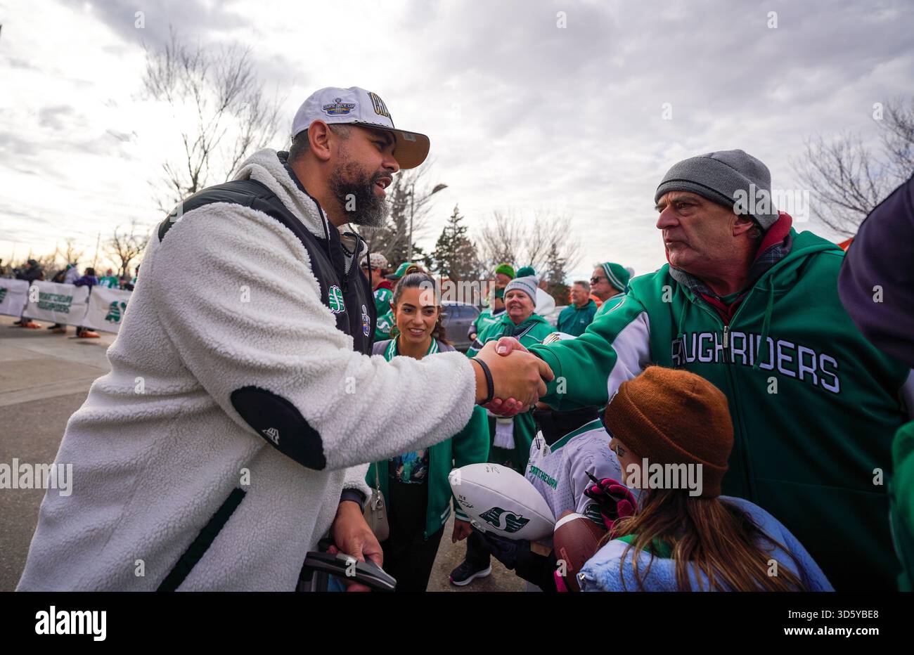 Saskatchewan Roughriders head coach Corey Mace speaks to a fan in front ...