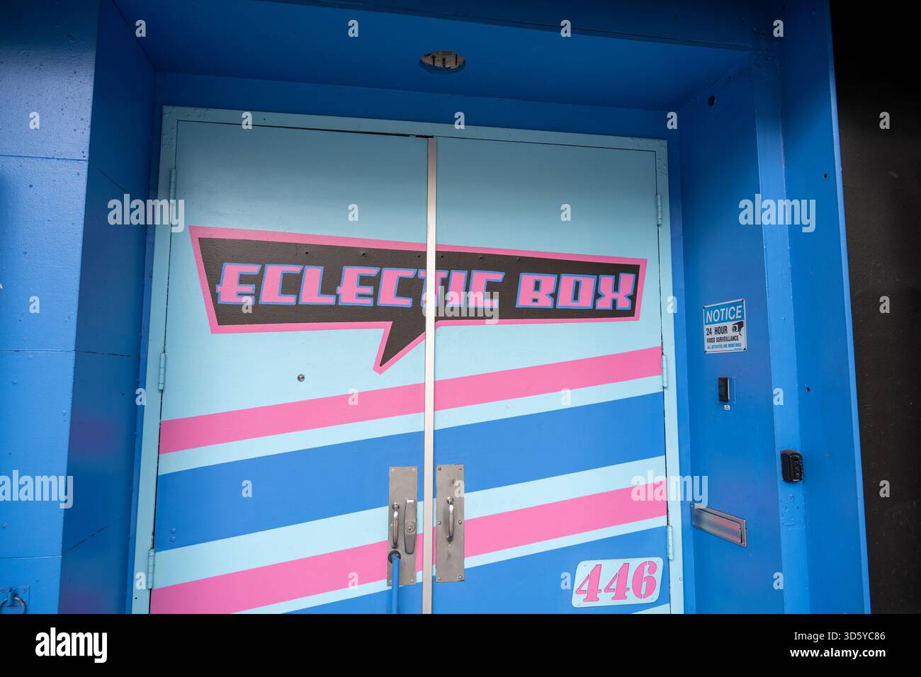 Colorful blue entry doors with Eclectic Box signage, pink and light ...