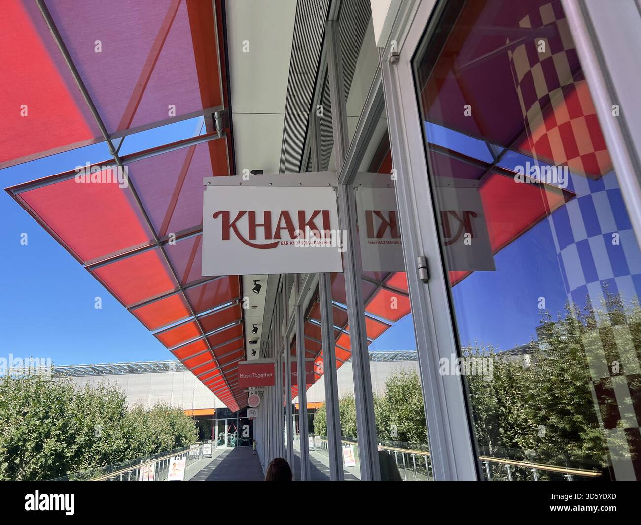 Exterior sign for Khaki Bar and Indian Canteen along covered walkway at ...