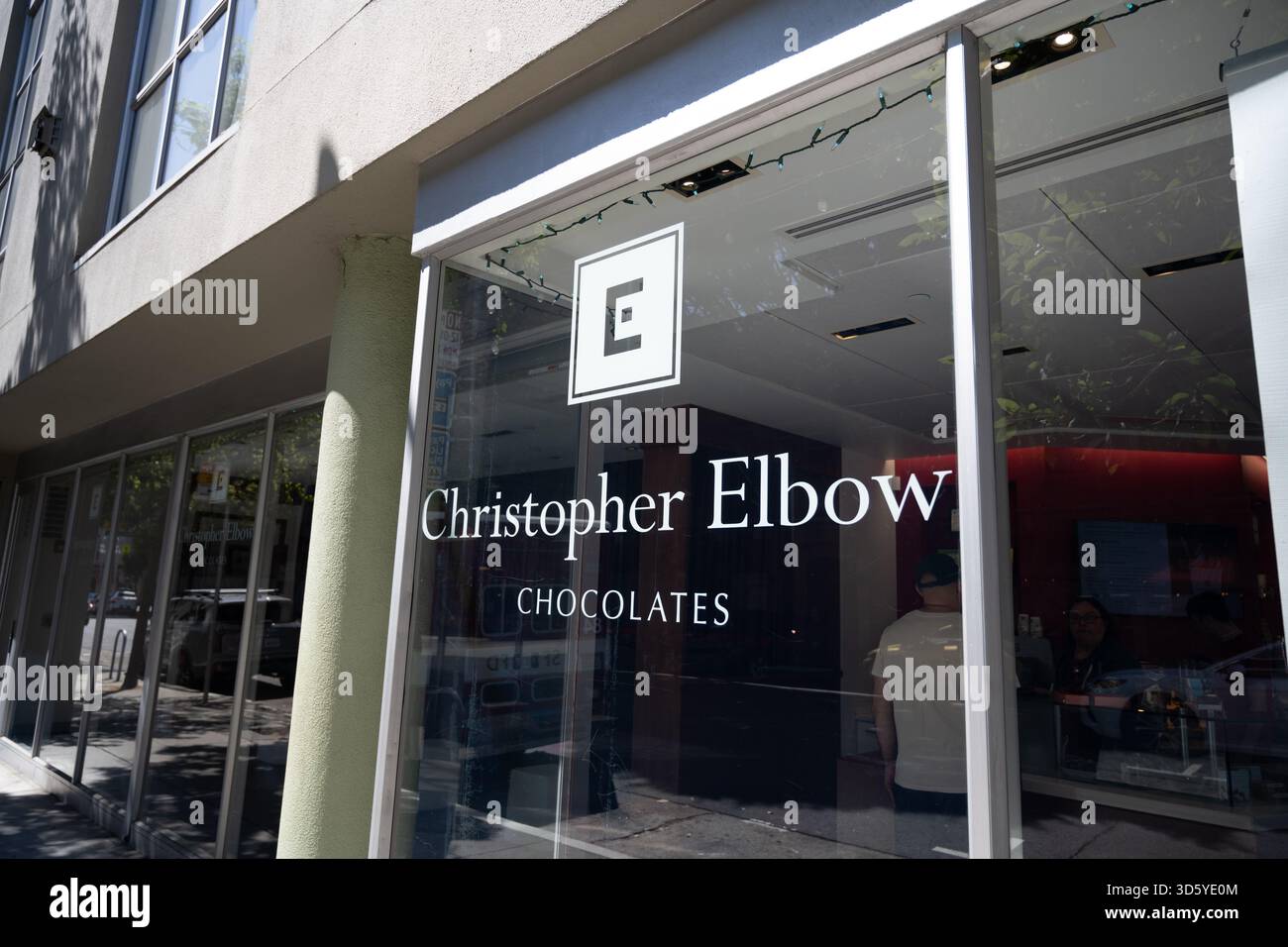 Storefront of Christopher Elbow Chocolates with logo visible on glass ...