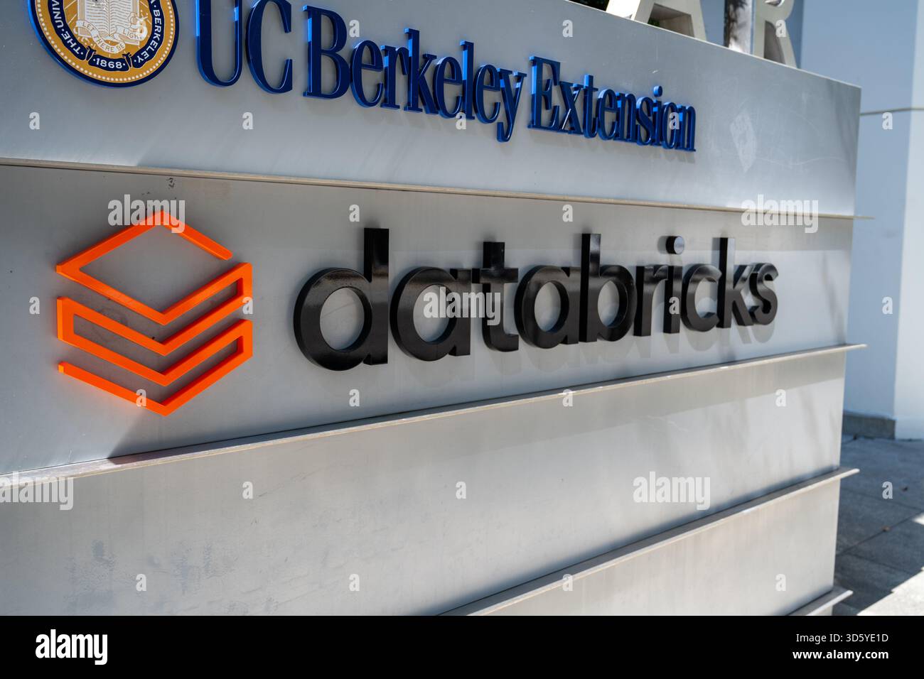 Close-up of Databricks logo and UC Berkeley Extension lettering on exterior sign outside office ...