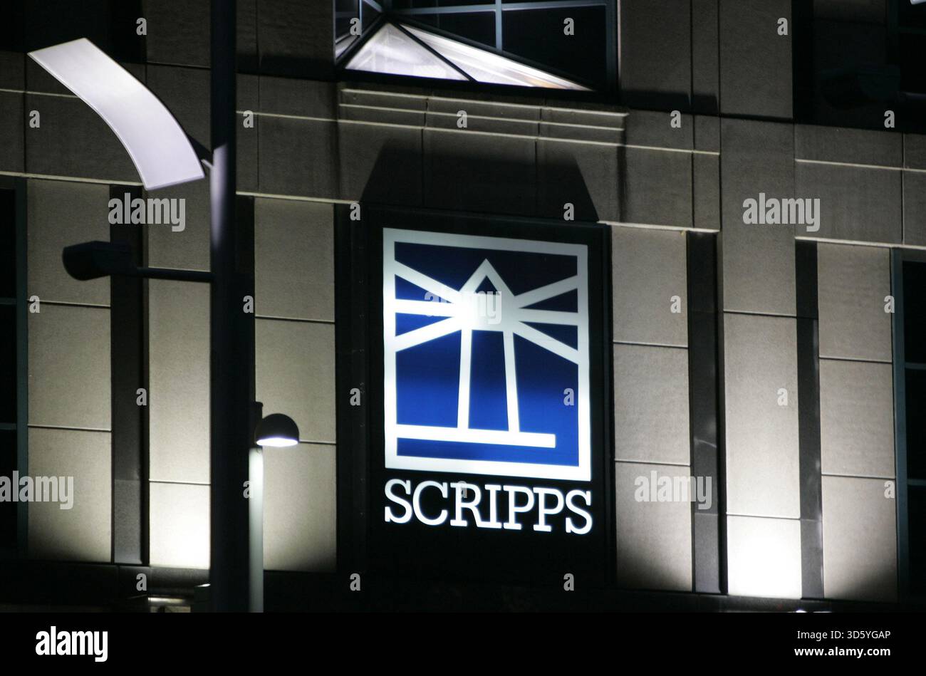 FILE - Floodlights light up the E.W. Scripps logo on the company's ...