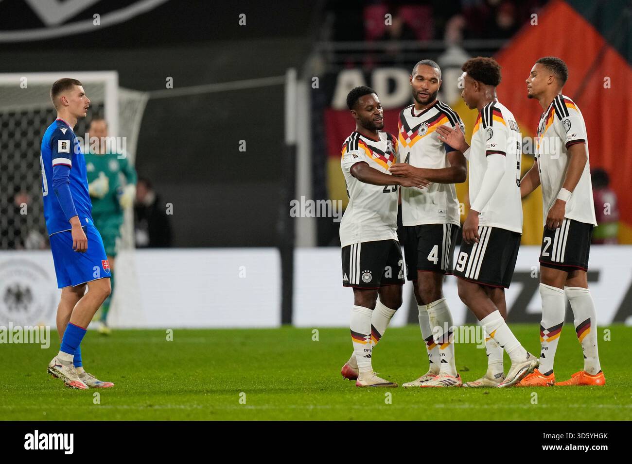 German players hug after winning a group A World Cup qualifiying soccer ...
