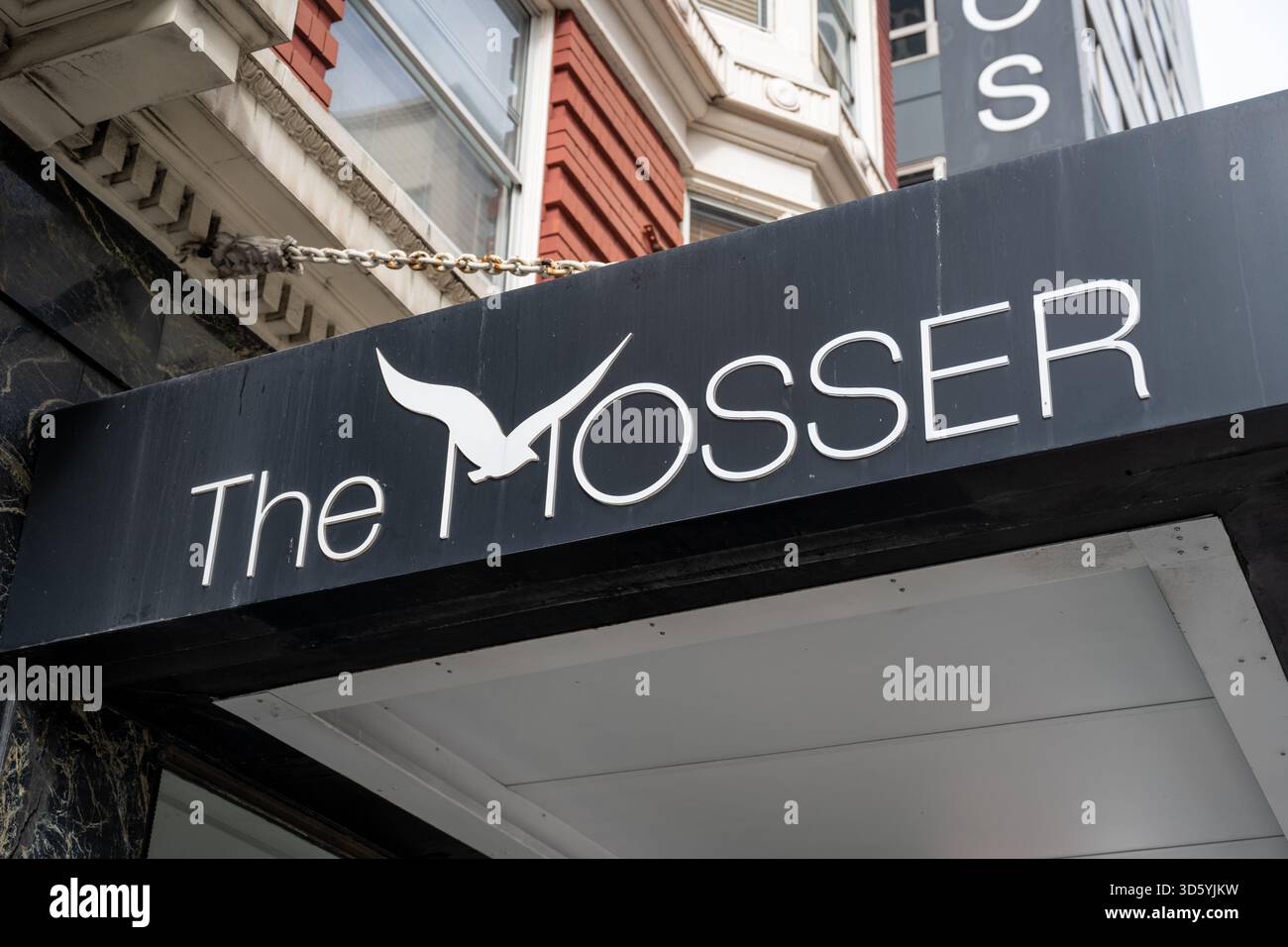 Exterior awning with "The Mosser" signage and bird logo on a city ...