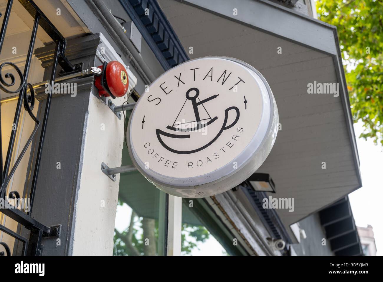 Round hanging sign for Sextant Coffee Roasters with logo on cafe ...