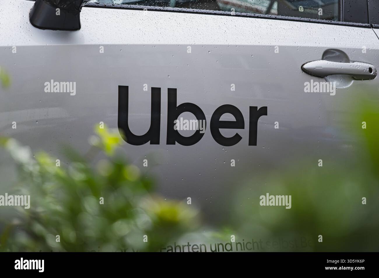 Close-up of an Uber vehicle with bold black logo on the door Stock ...