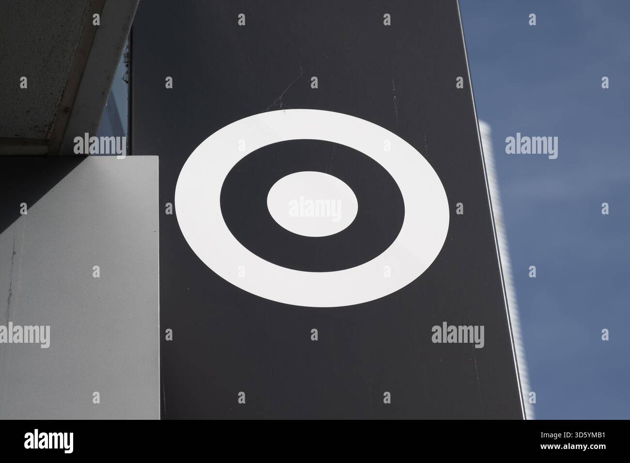 Close-up of Target bullseye logo on black storefront sign in sunlight ...
