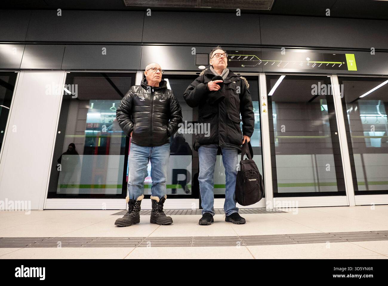 Nathan Ray, right, and Julian exit the REM light rail train at McGill ...