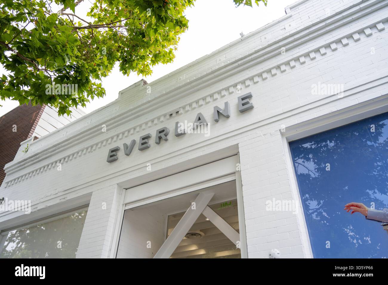 Storefront exterior of Everlane clothing retailer with white brick ...