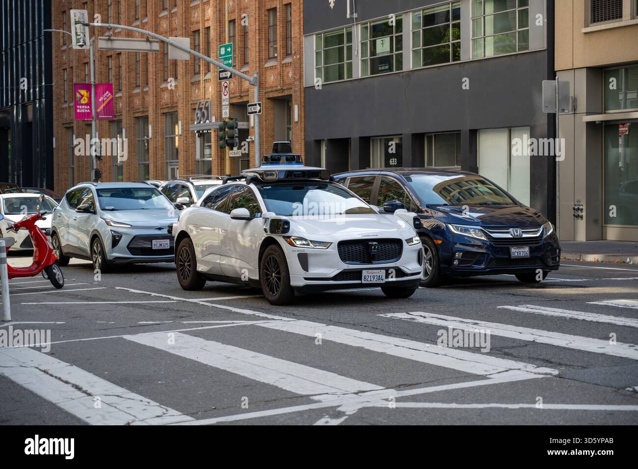 Waymo self-driving car with roof-mounted sensors stopped at ...
