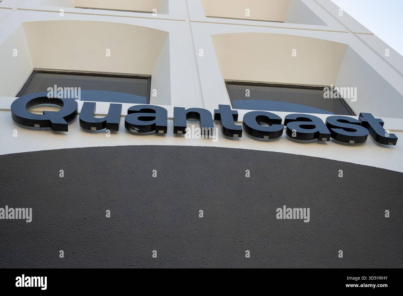 Close-up of Quantcast logo on office building facade with arched ...