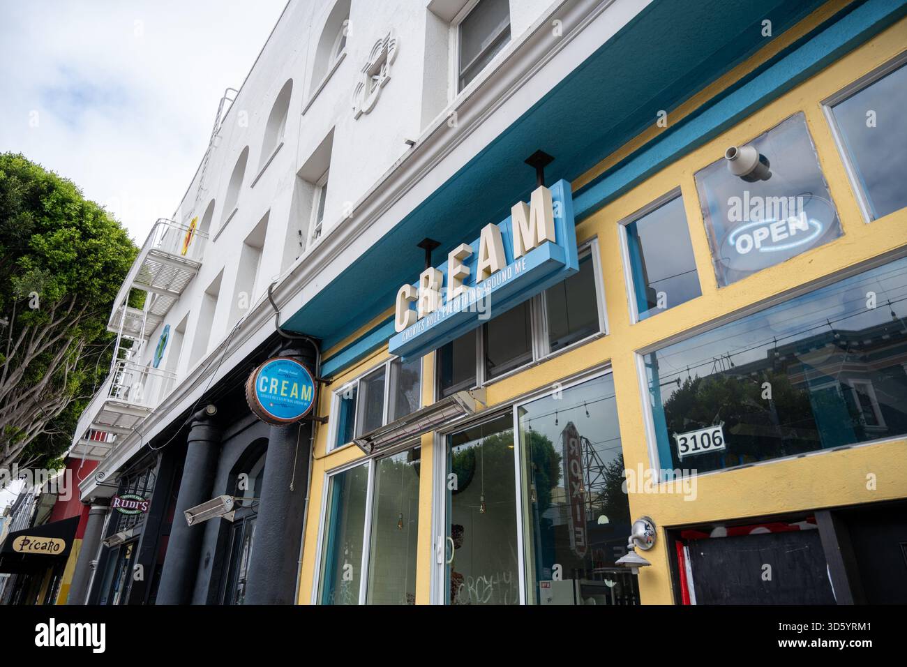 Storefront of CREAM ice cream shop with blue and yellow facade, open ...