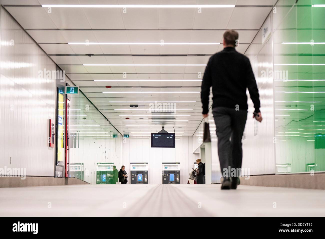 People walk towards the REM light rail system at McGill station, in ...