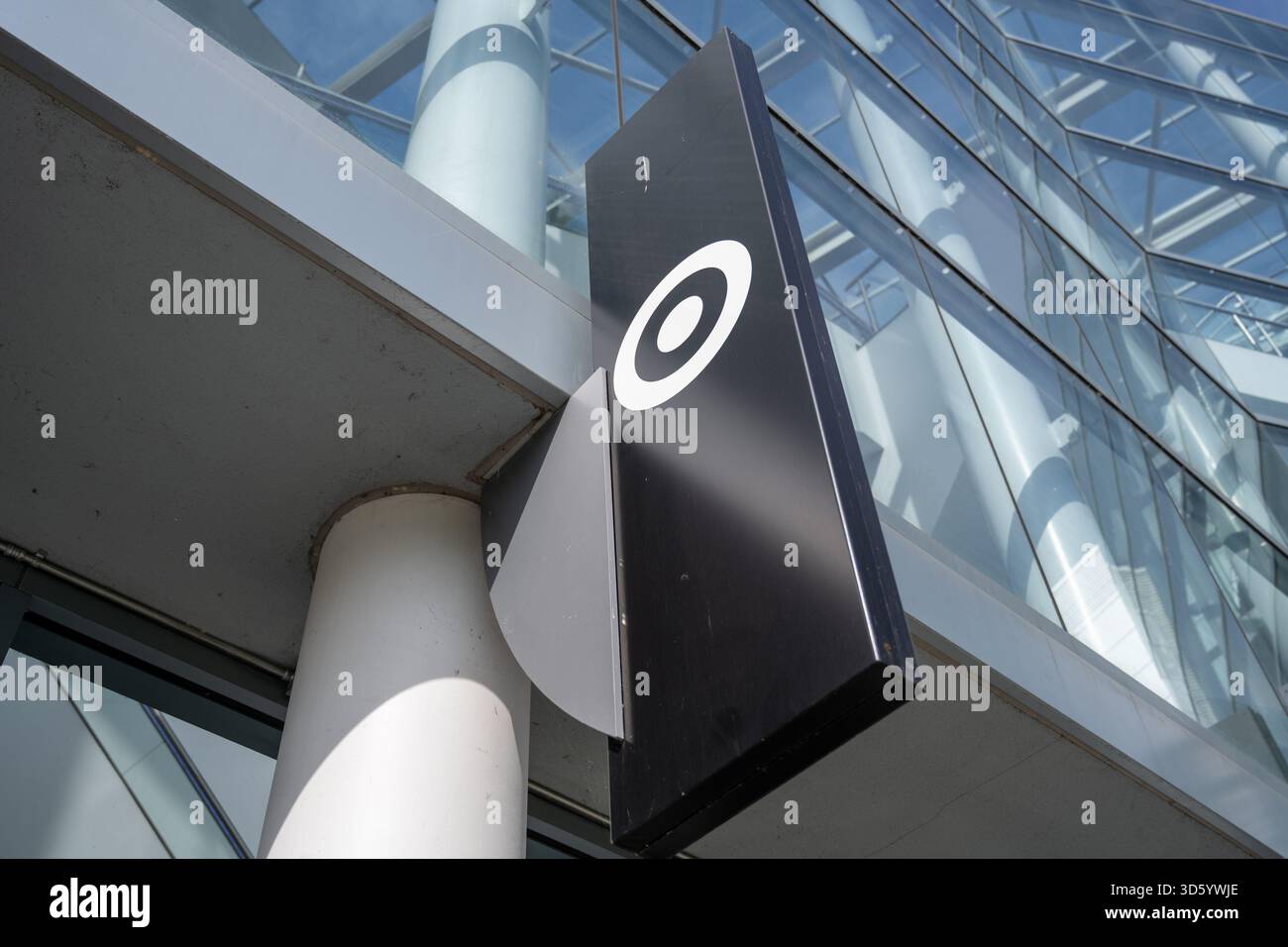 Close-up of projecting sign with circular logo on modern glass and ...