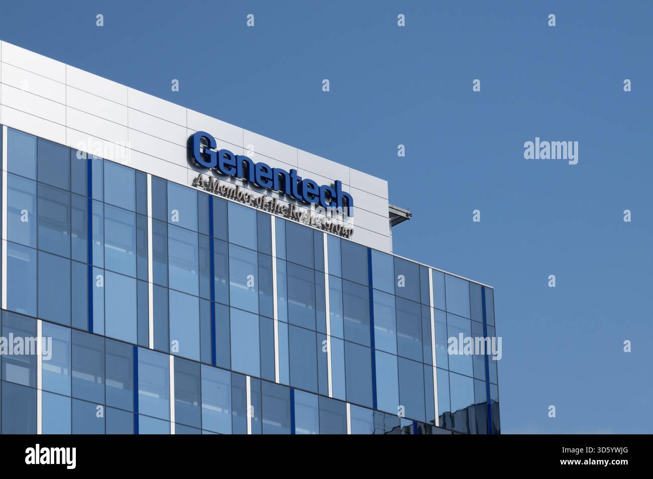 Exterior of Genentech office building with logo on glass facade against ...