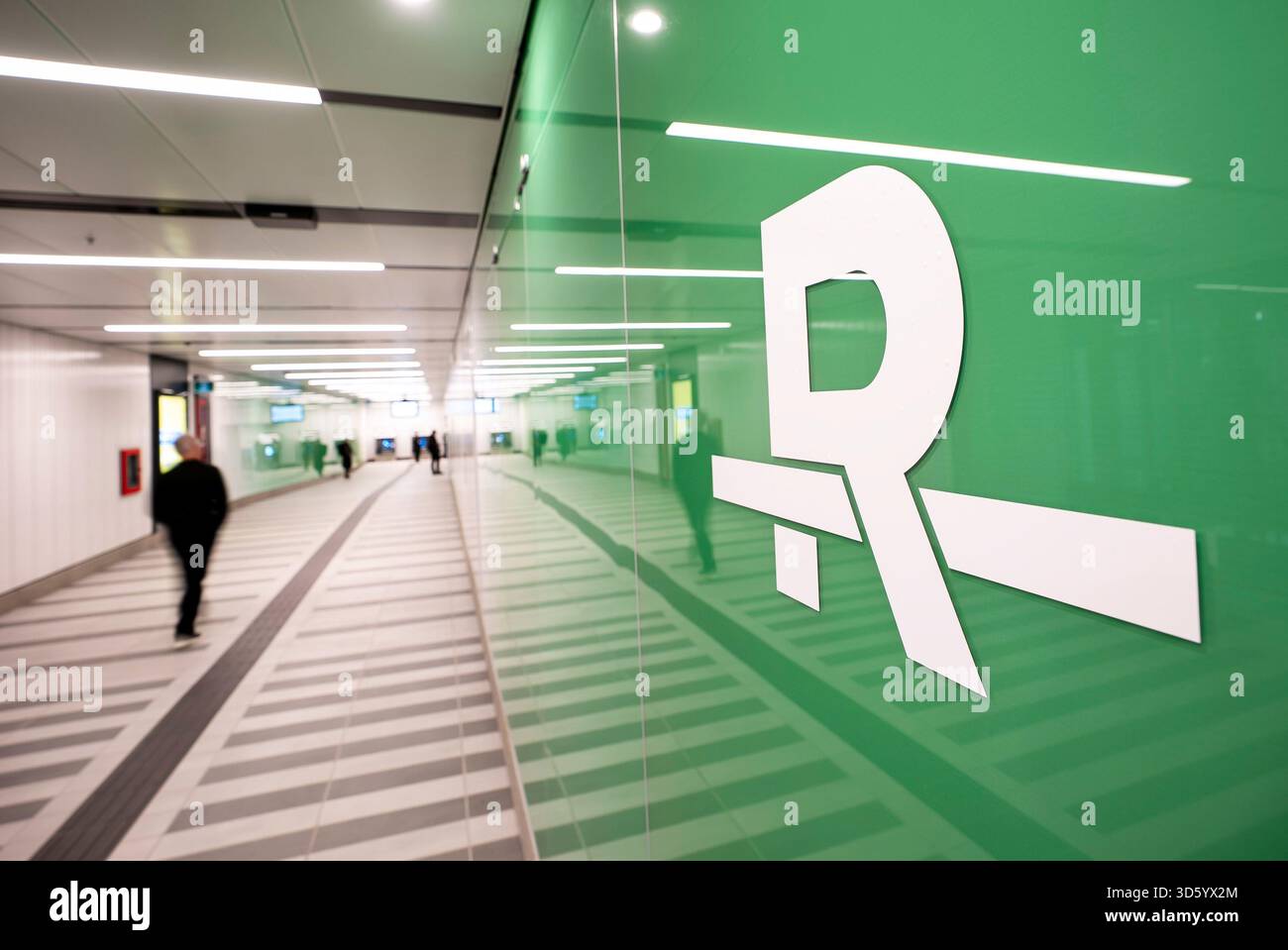 People walk towards the REM light rail system at McGill station, in ...