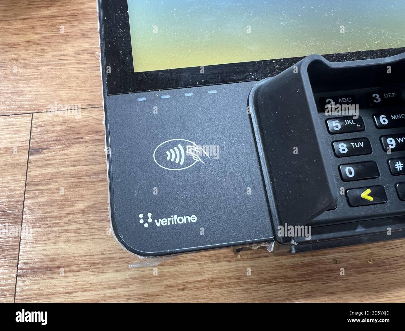 Verifone logo on contactless payment NFC reader at checkout stand in ...