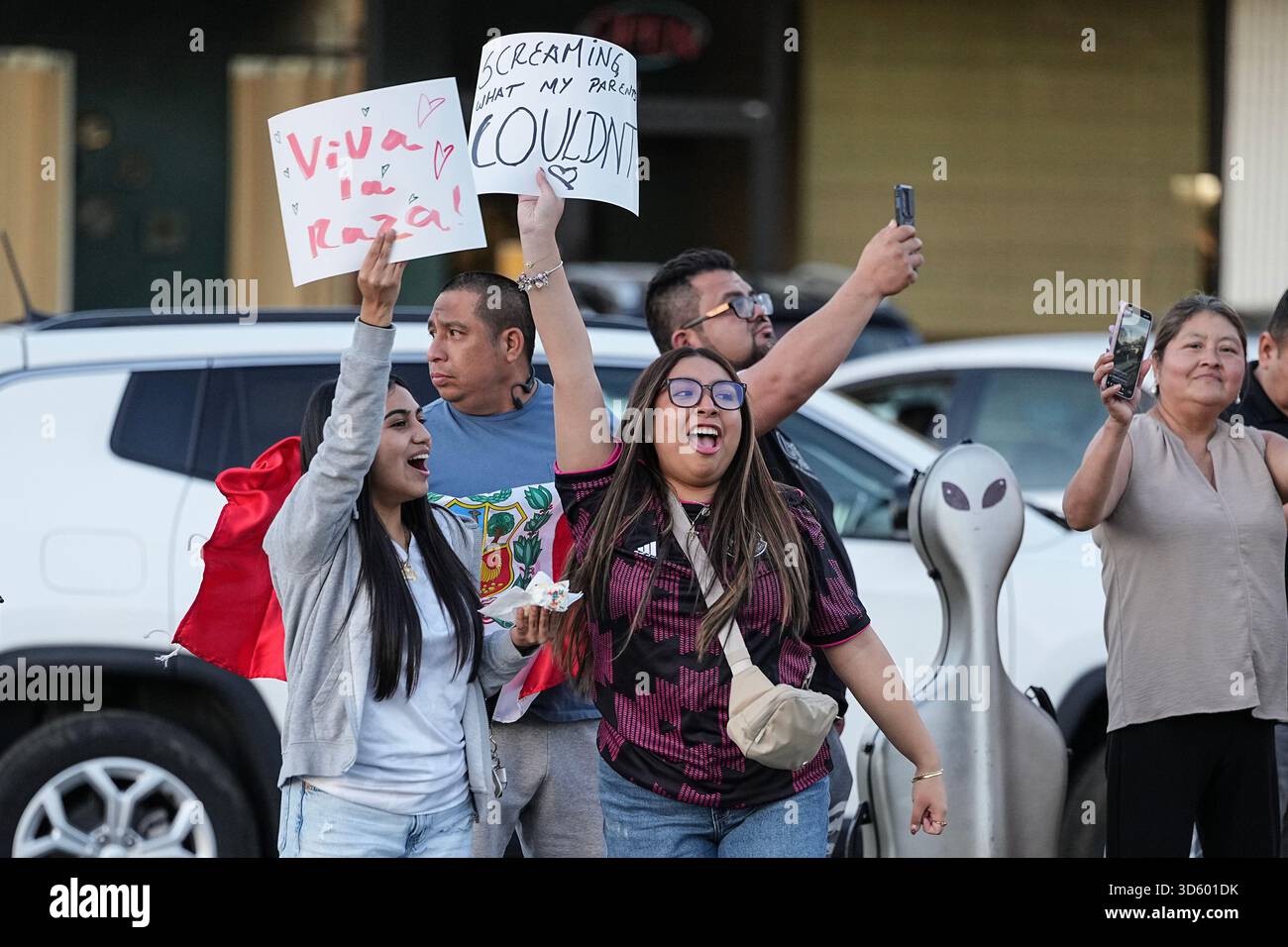 Protesters holds signs amidst the arrival of federal law enforcement ...