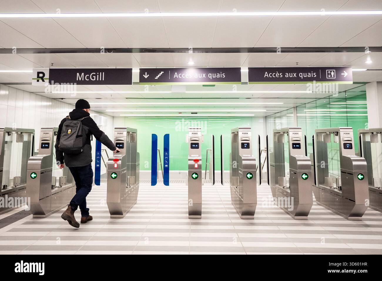 A person enters the REM light rail system at McGill station, in ...