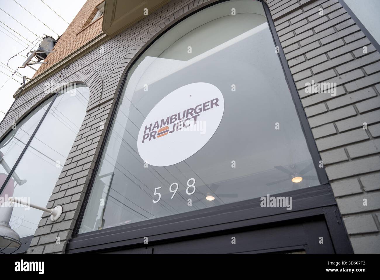 Storefront of Hamburger Project with logo on arched window and address ...