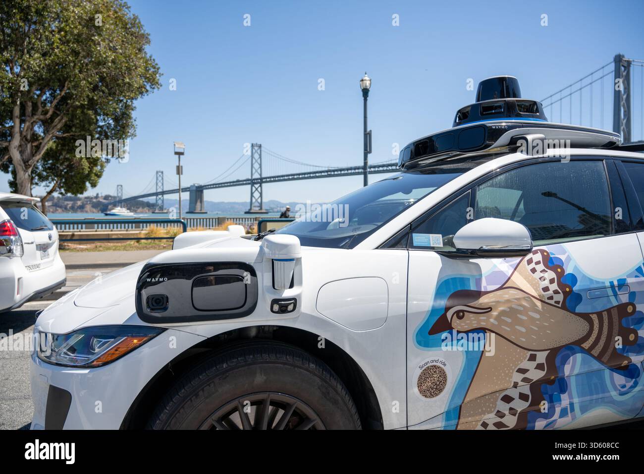 Self-driving Waymo car with rooftop lidar and bird-themed mural on the ...