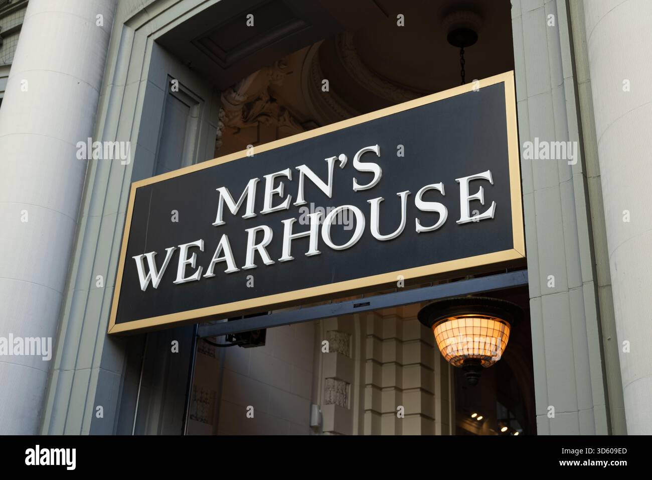 Men's Wearhouse sign at clothing store entrance with classical columns ...