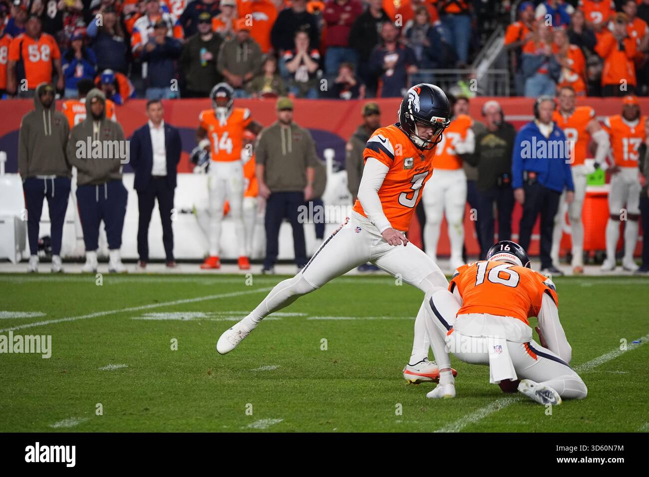 Denver Broncos kicker Wil Lutz (3) prepares to kick as holder Jeremy ...