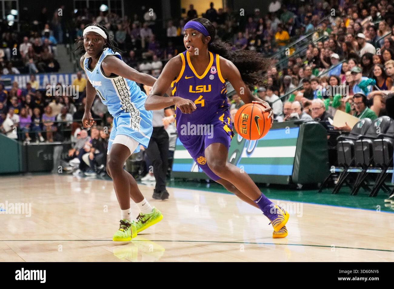 LSU guard Flau'Jae Johnson (4) drives past Tulane guard Jayda Brown in ...