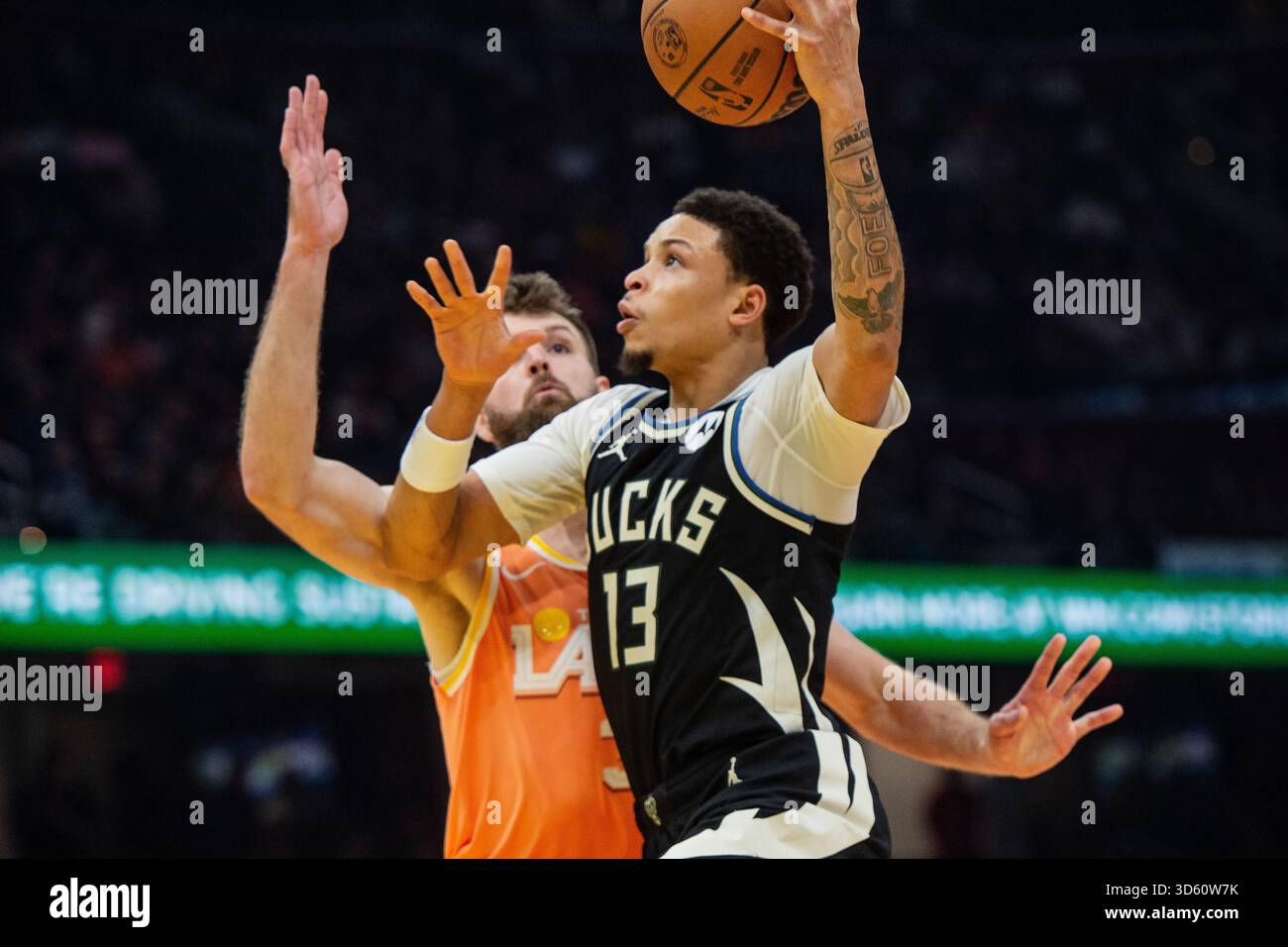 Milwaukee Bucks' Ryan Rollins (13) shoots in front of Cleveland ...