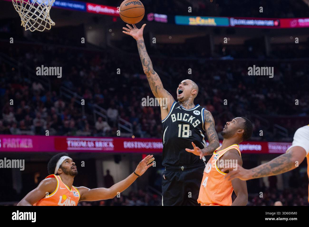 Milwaukee Bucks' Kyle Kuzma (18) shoots as Cleveland Cavaliers' Jarrett ...