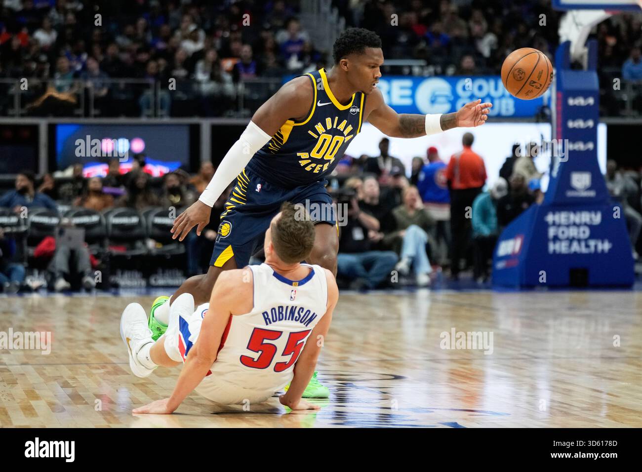Detroit Pistons forward Duncan Robinson, bottom, draws a charge on ...