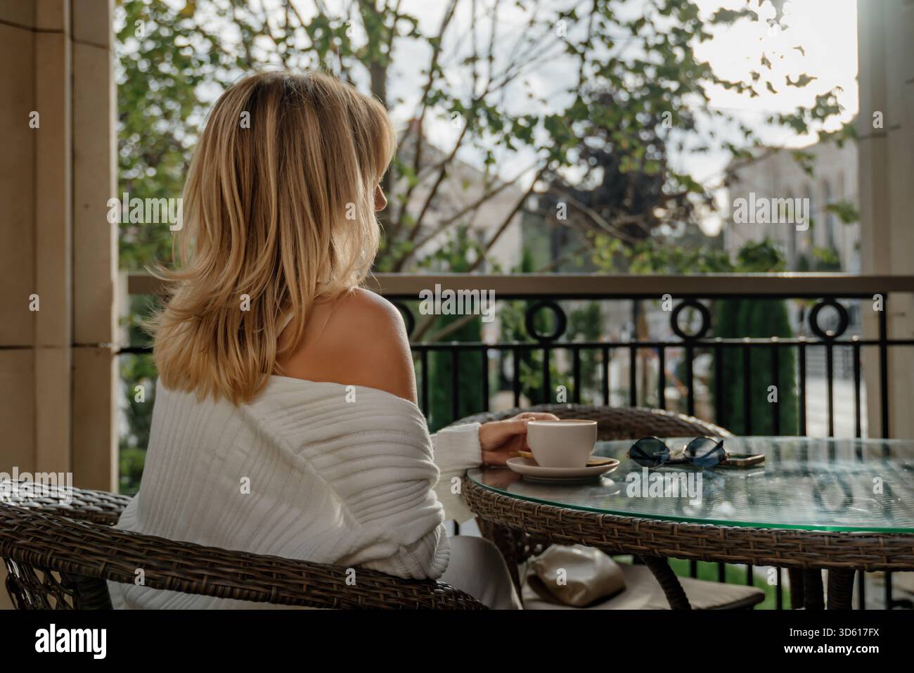 Woman Balcony Coffee Relaxation - Woman drinks coffee while relaxing on ...