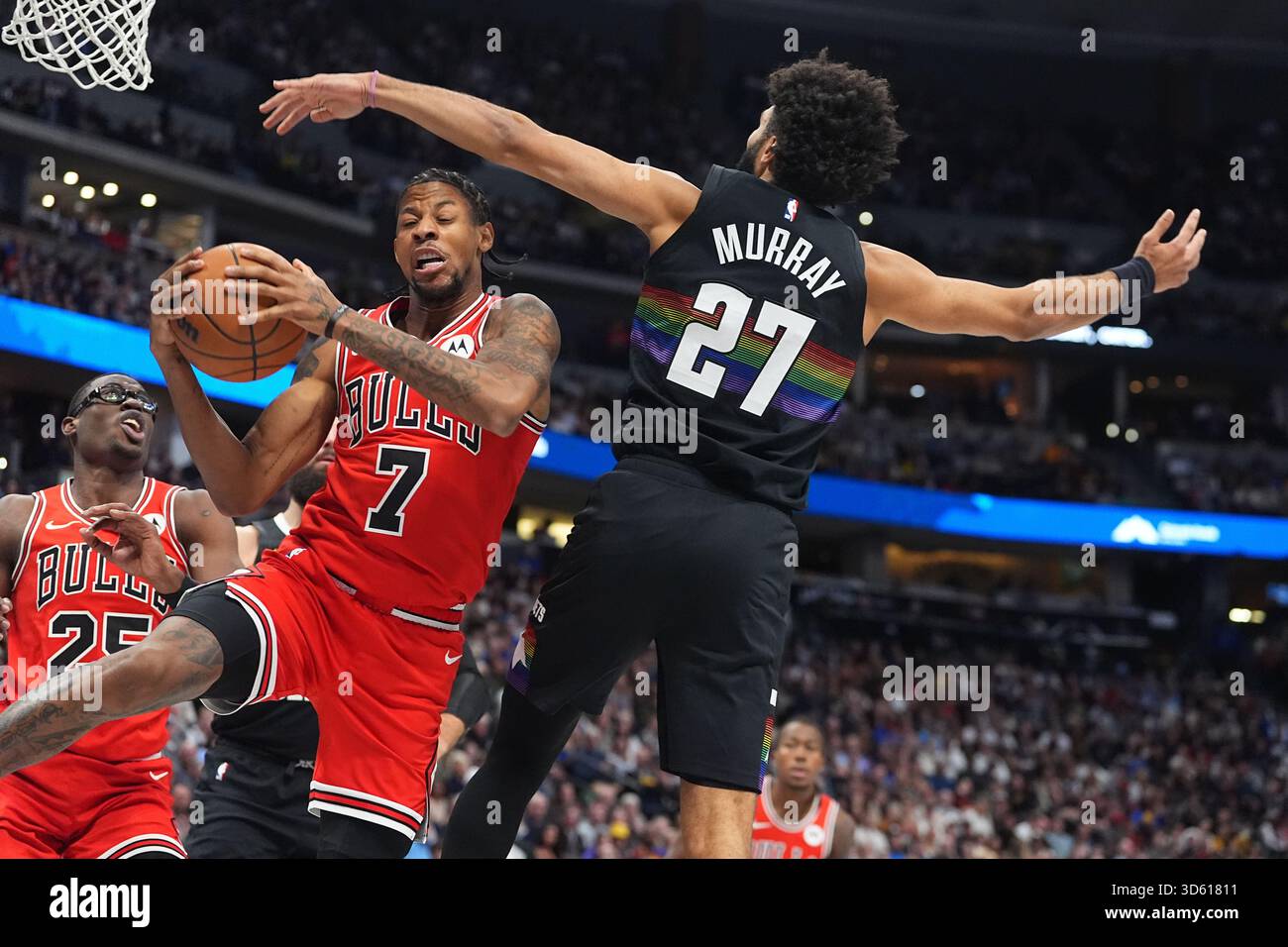 Chicago Bulls forward Dalen Terry, left, pulls in a rebound as Denver ...