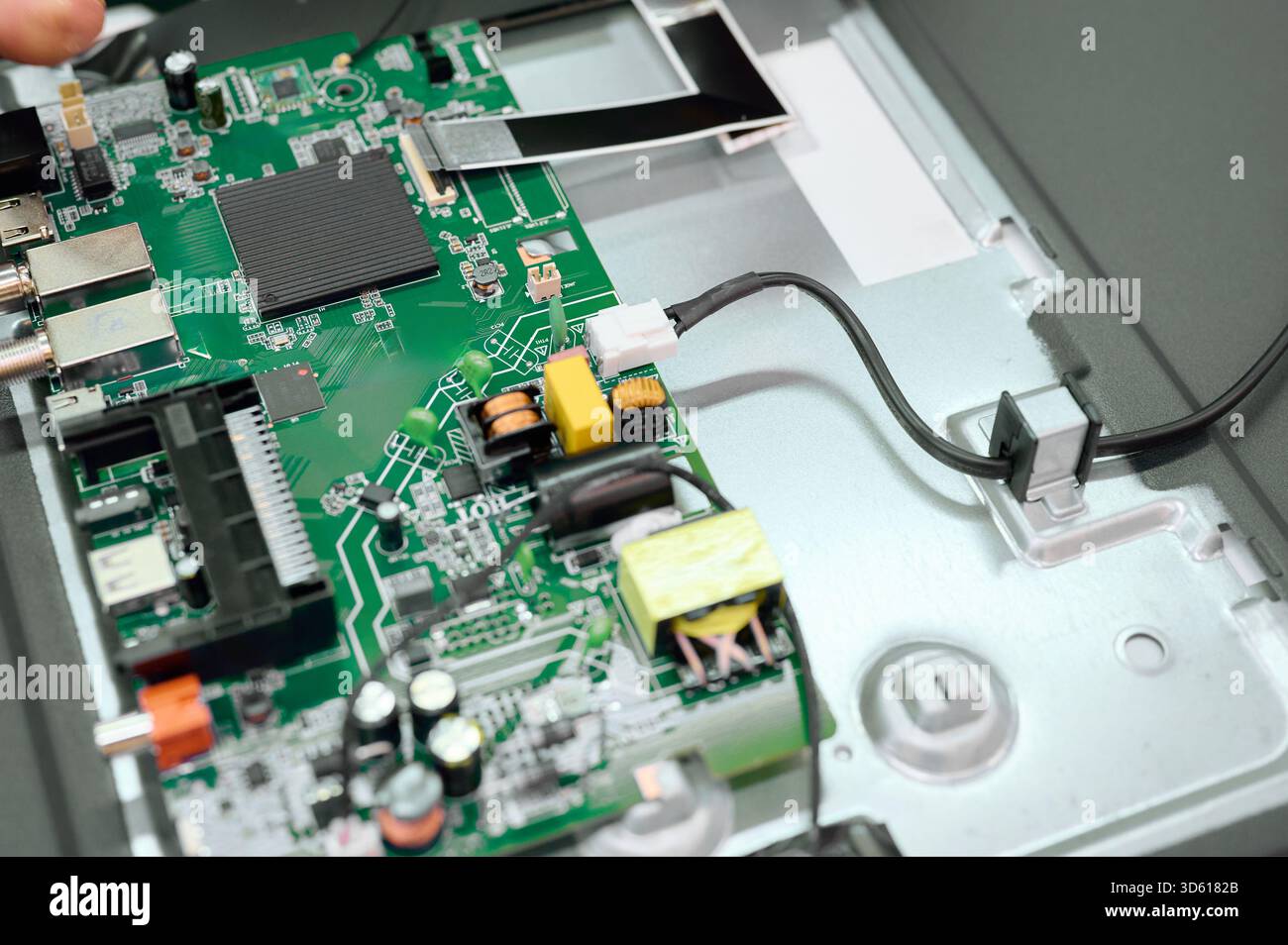 TV assembly plant featuring a close-up of an electronic circuit board ...