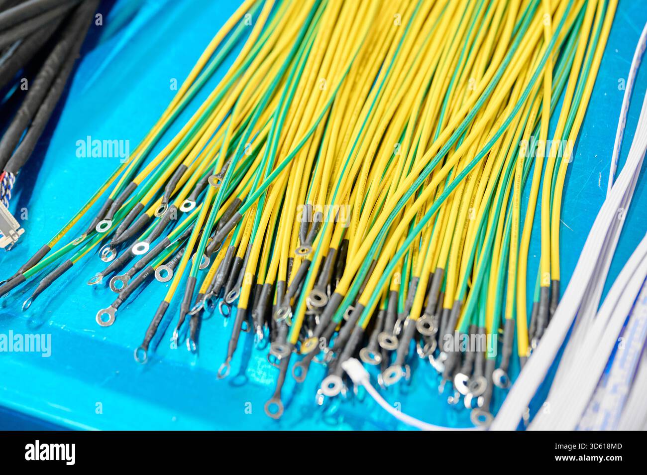 Colorful electrical wires organized neatly on a blue table ready for ...