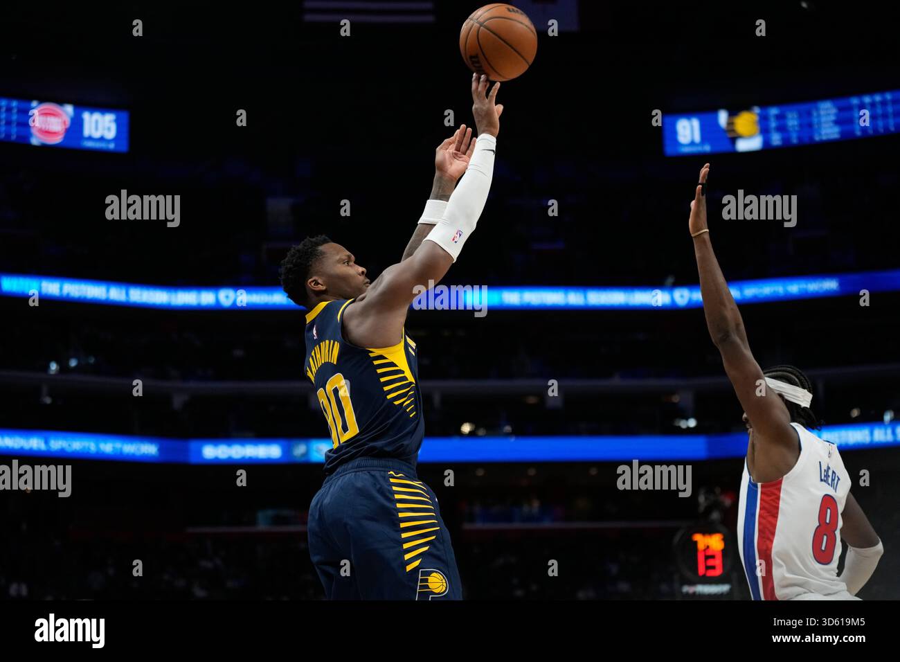 Indiana Pacers guard Bennedict Mathurin, left, shoots against Detroit Pistons guard Caris LeVert ...