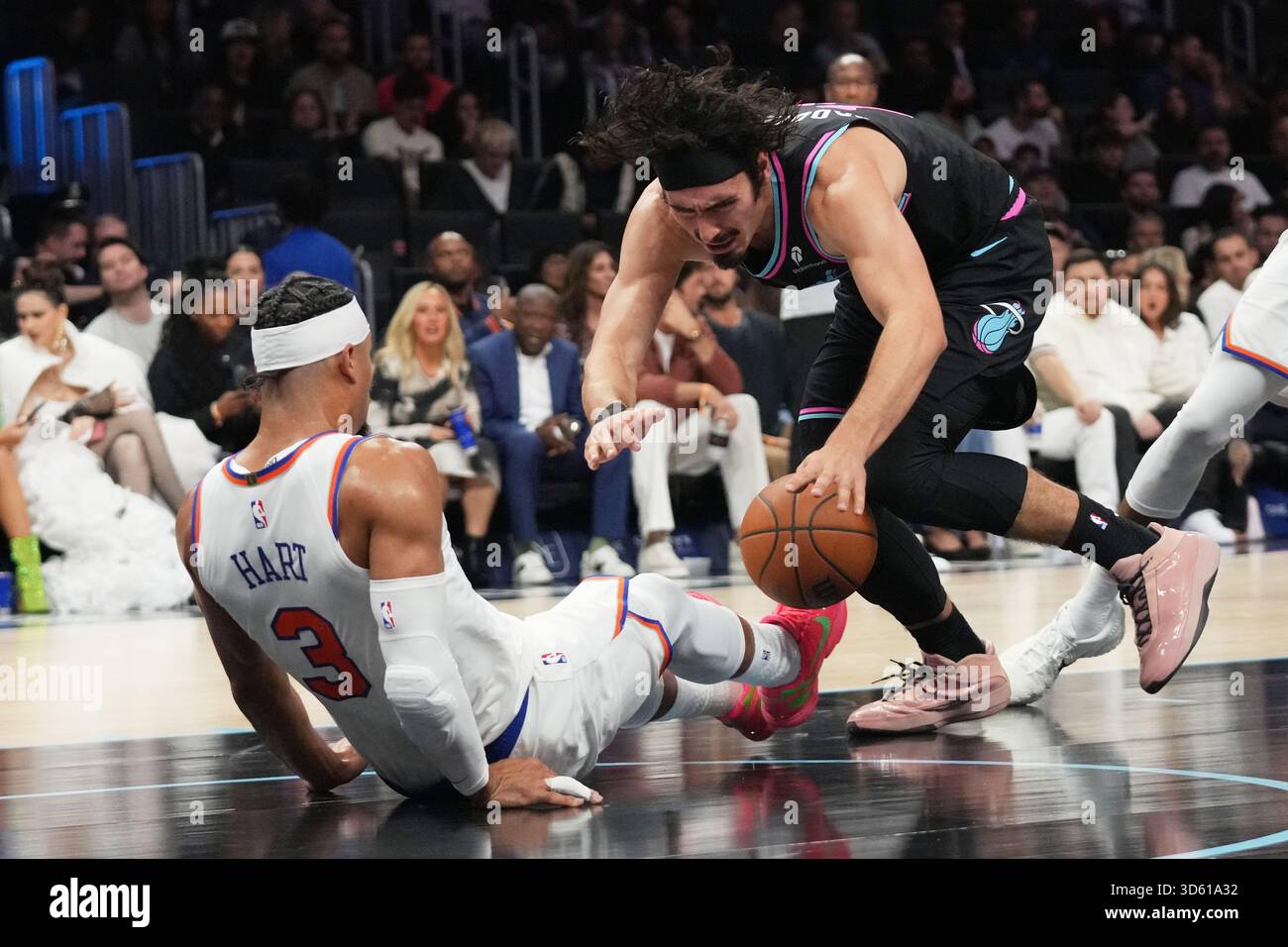Miami Heat forward Jaime Jaquez Jr., right, falls tot he court as New ...