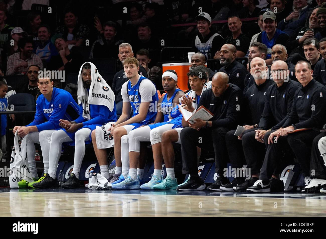 Dallas Mavericks players and coaches watch play during the second half ...