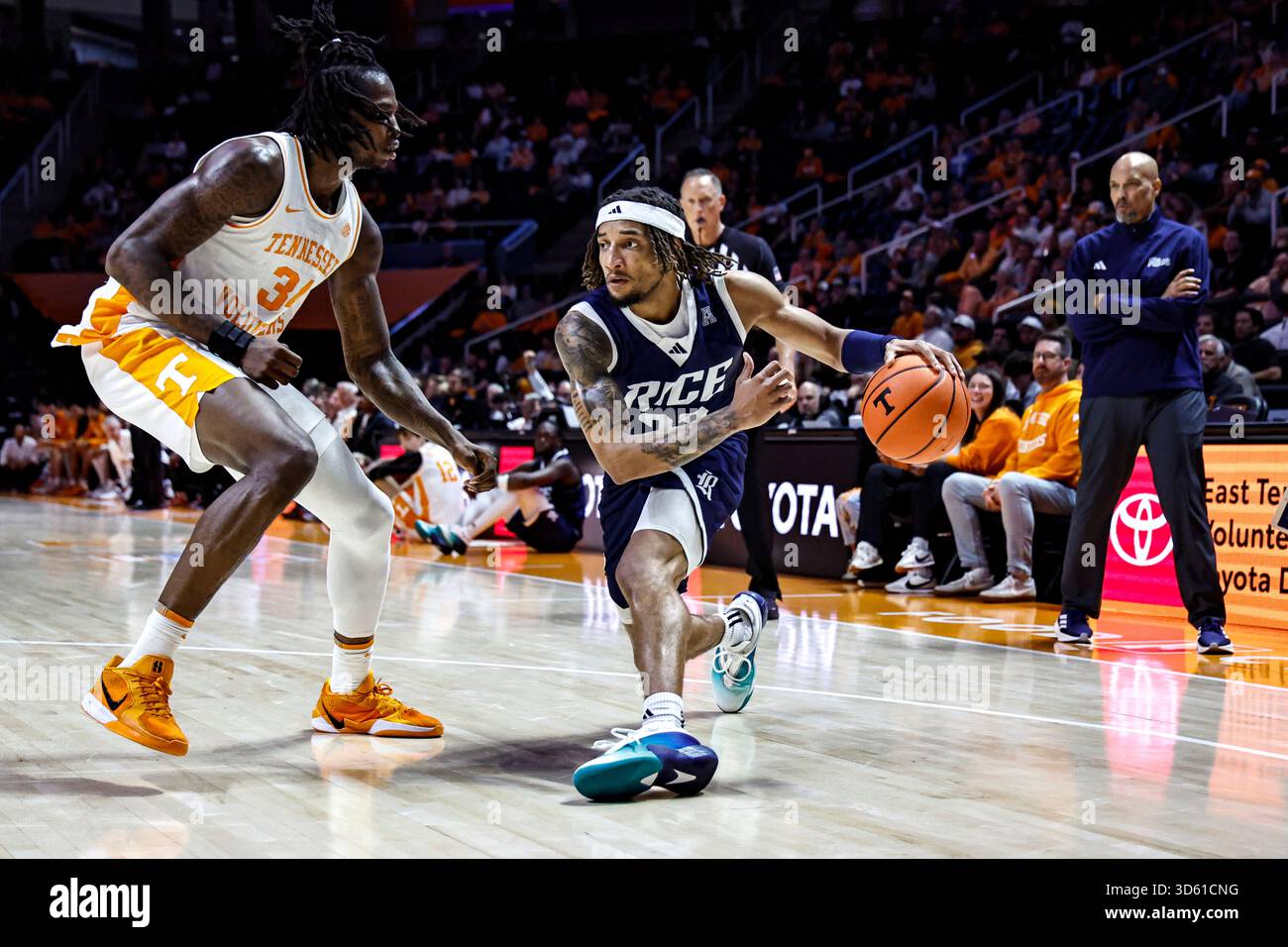 Rice guard Nick Anderson, center front, drives as he is defended by ...