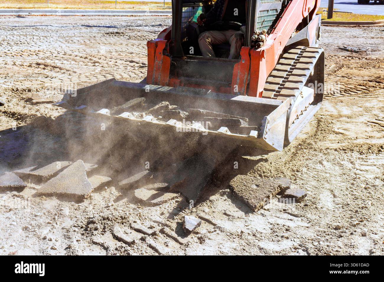 Skid steer loader works on construction site, clearing debris leveling ...