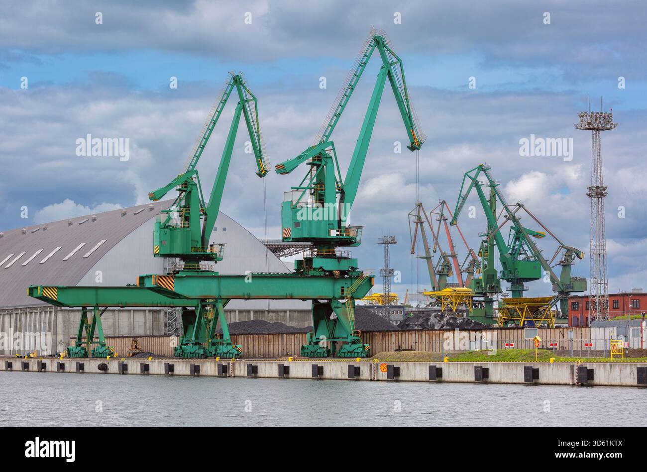 Large green gantry cranes at a cargo terminal in the port of Gdynia ...
