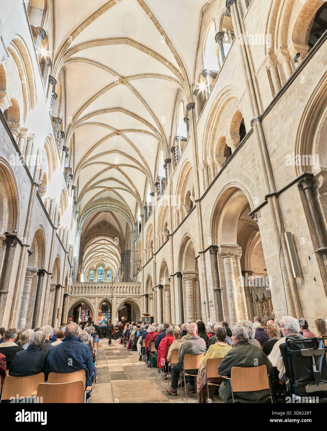 Concert goers in the nave of the medieval christian cathedral at ...
