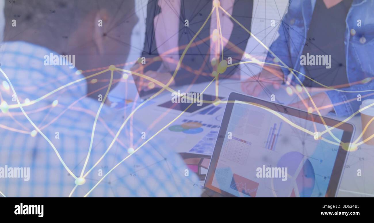 Reviewing team studying laptop charts, reports at office meeting in ...
